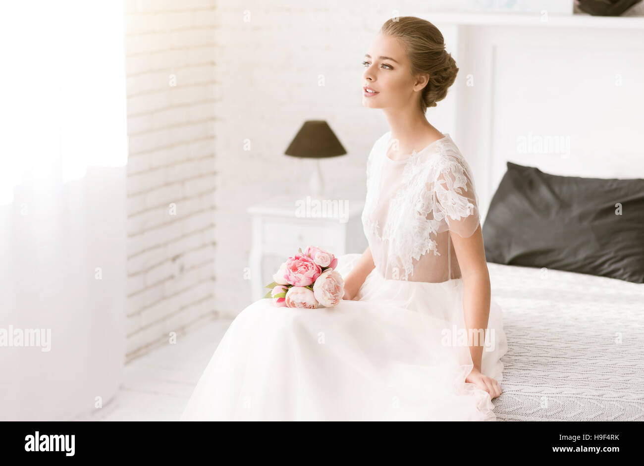 Bride sitting on bed hi-res stock photography and images - Alamy