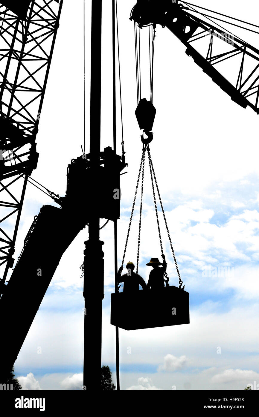 construction worker with use crane hook carry workers to work at site ...