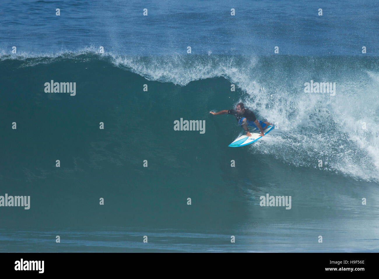 Deep backside tube riding Stock Photo - Alamy