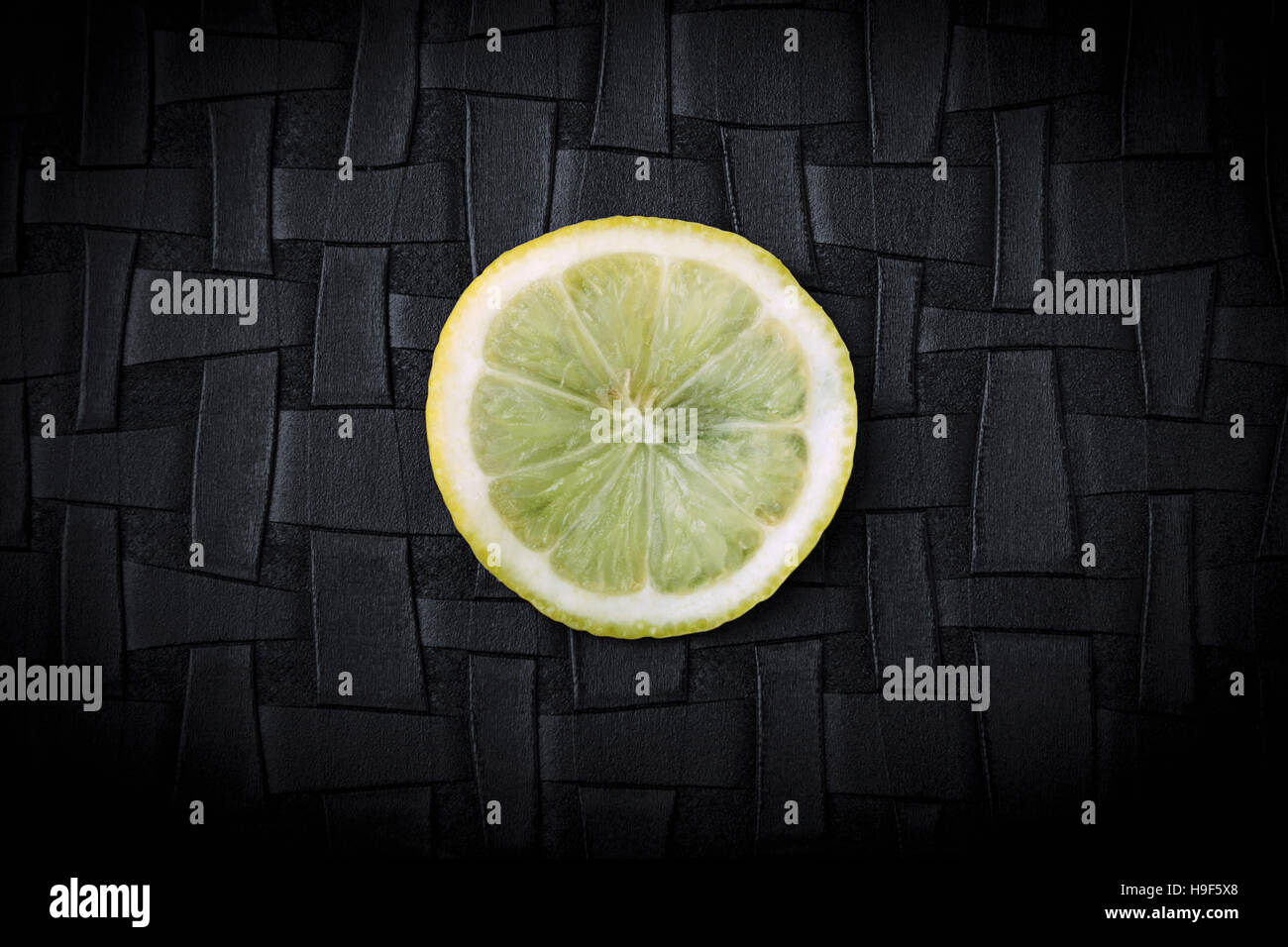 Slice of lemon on a leather background Stock Photo - Alamy