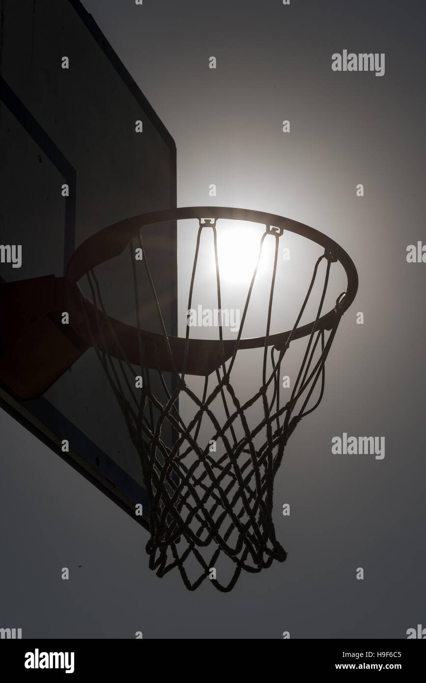 Sun dropping into a basketball net Stock Photo - Alamy