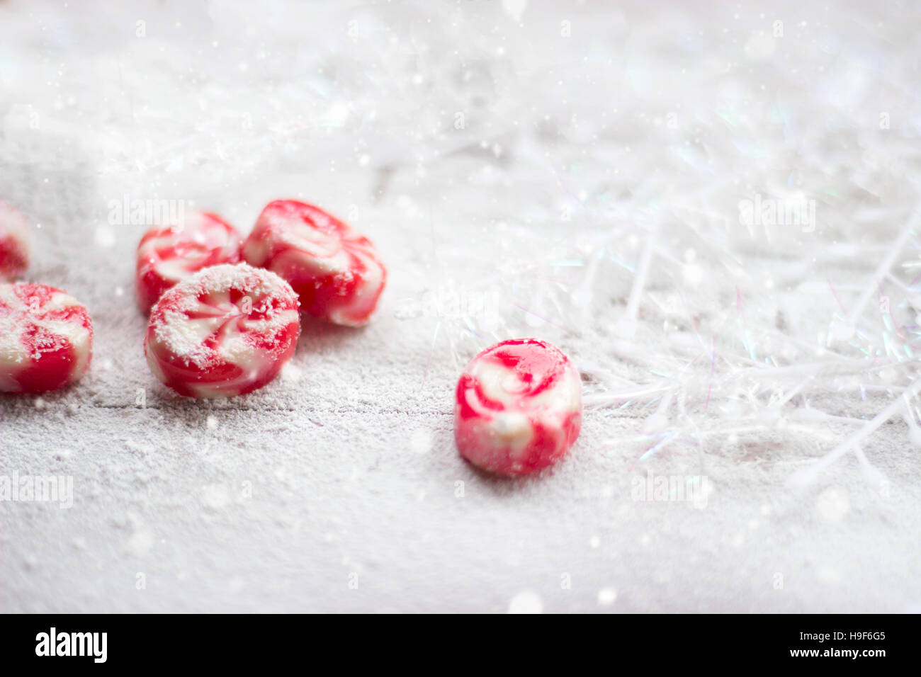 Winter background - candies on white wooden background covered with ...