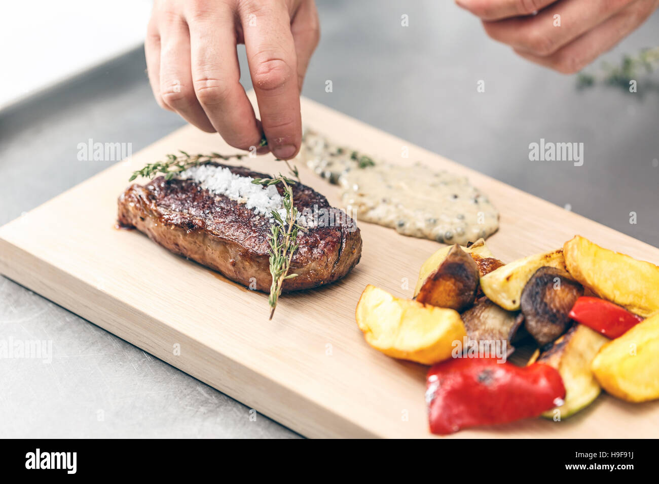 Chef serving beef steak Stock Photo - Alamy