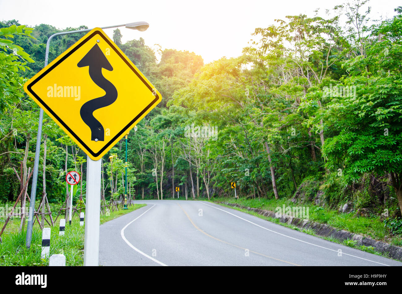 Blue curvy road ahead sign hi-res stock photography and images - Alamy