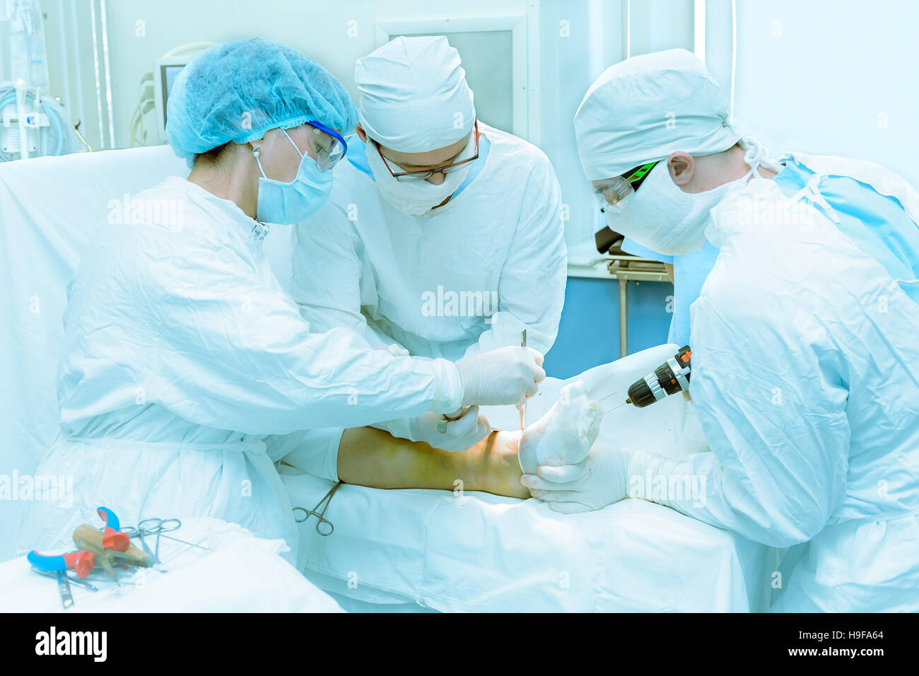 Group of doctors doing the actual operation in the traumatology ...