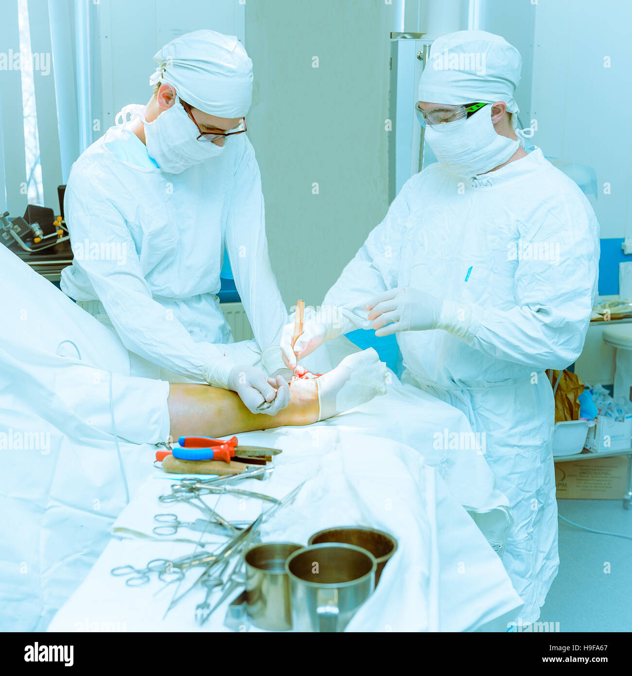 Group of doctors doing the actual operation in the traumatology ...