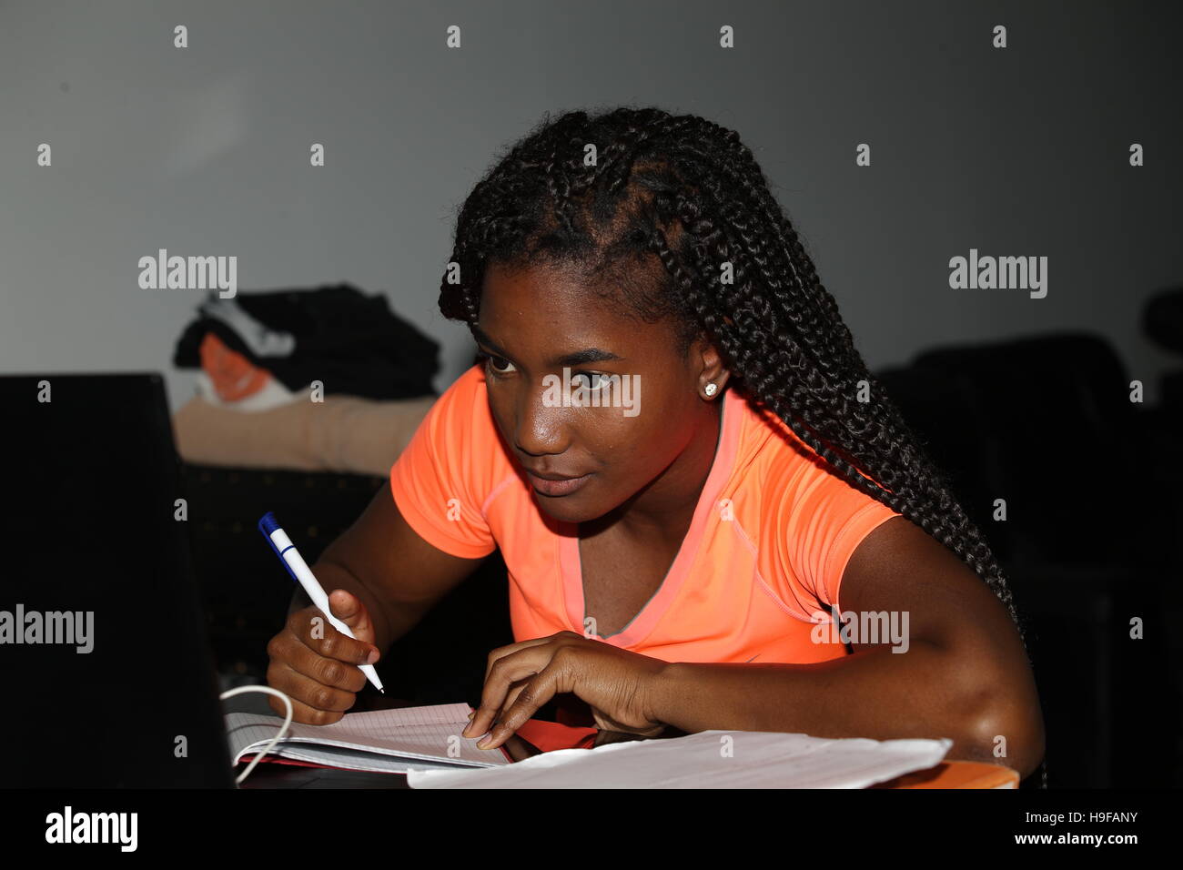 Black teenage girl doing her homework Stock Photo - Alamy
