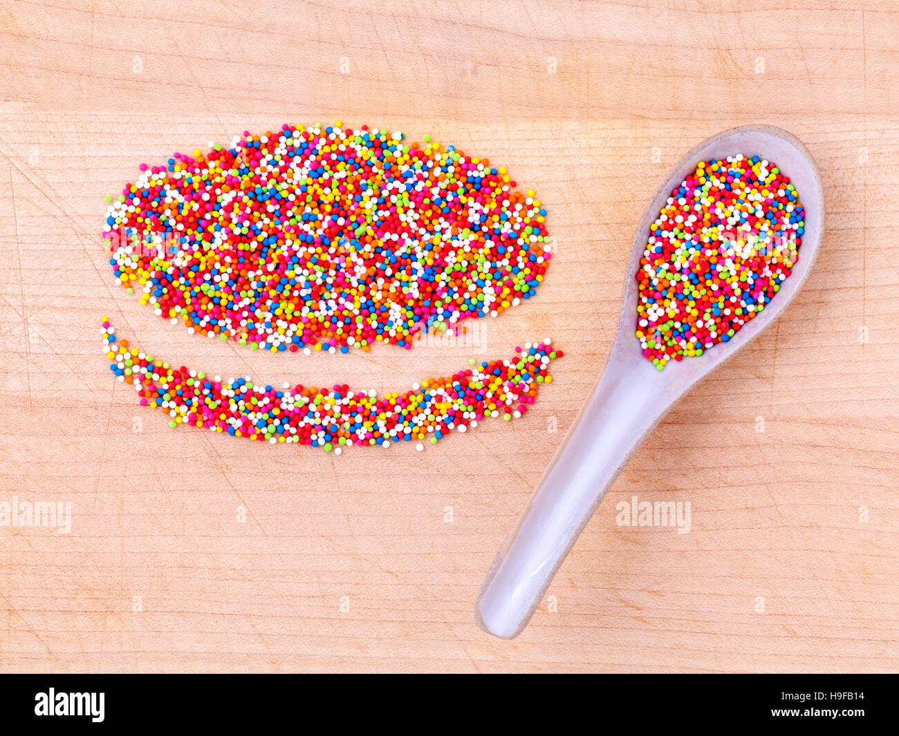 Colourful topping baking in wooden spoon and the shape of macaro Stock ...