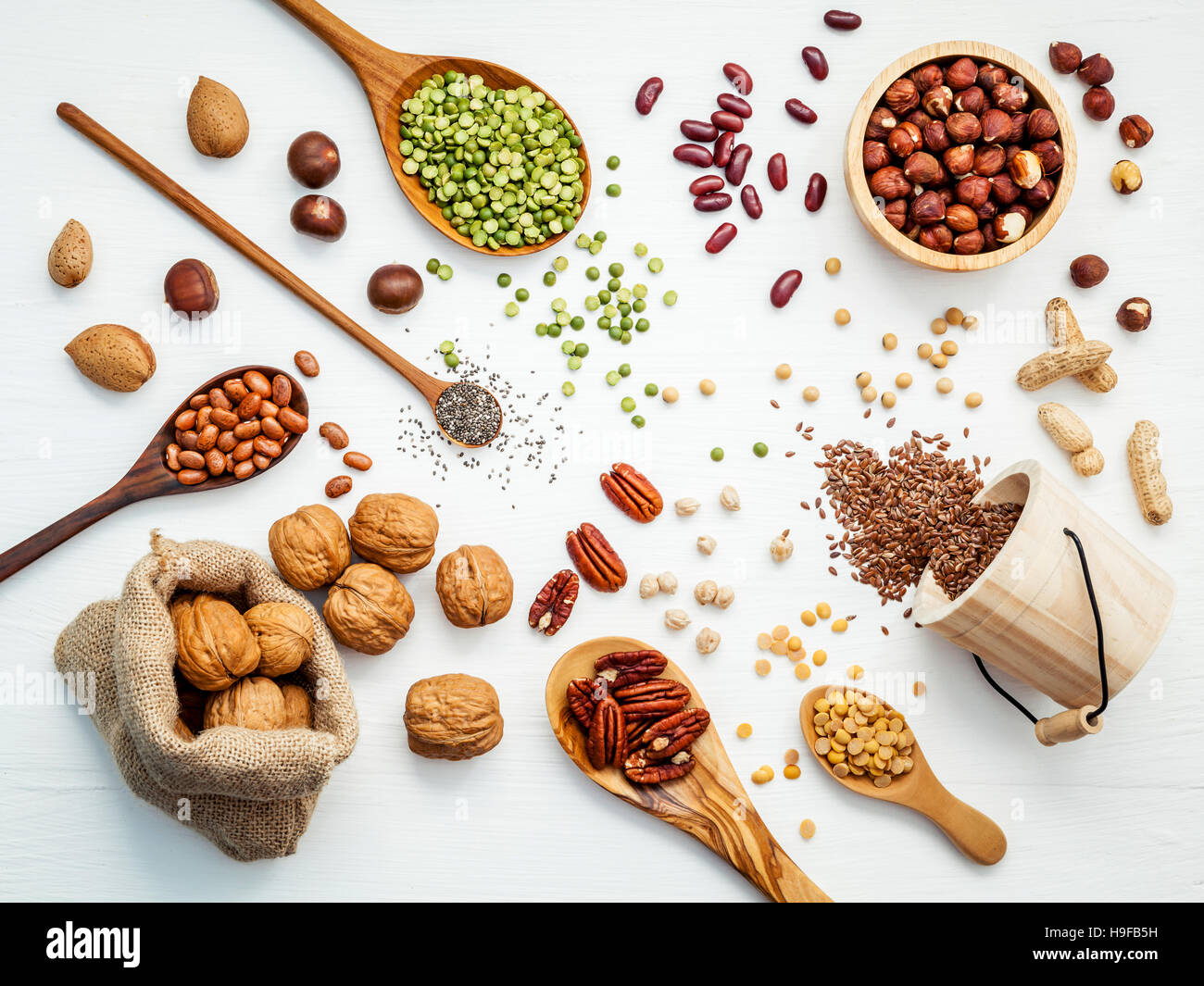 Bowls and spoons of various legumes and different kinds of nuts Stock ...
