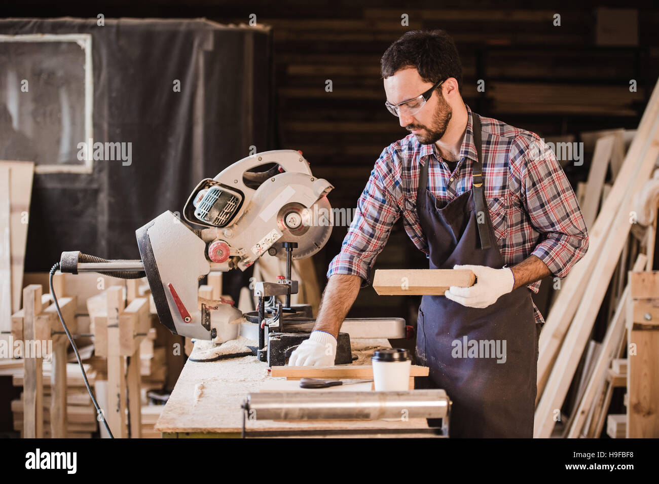 profession, carpentry, woodwork people concept - carpenter with wood ...