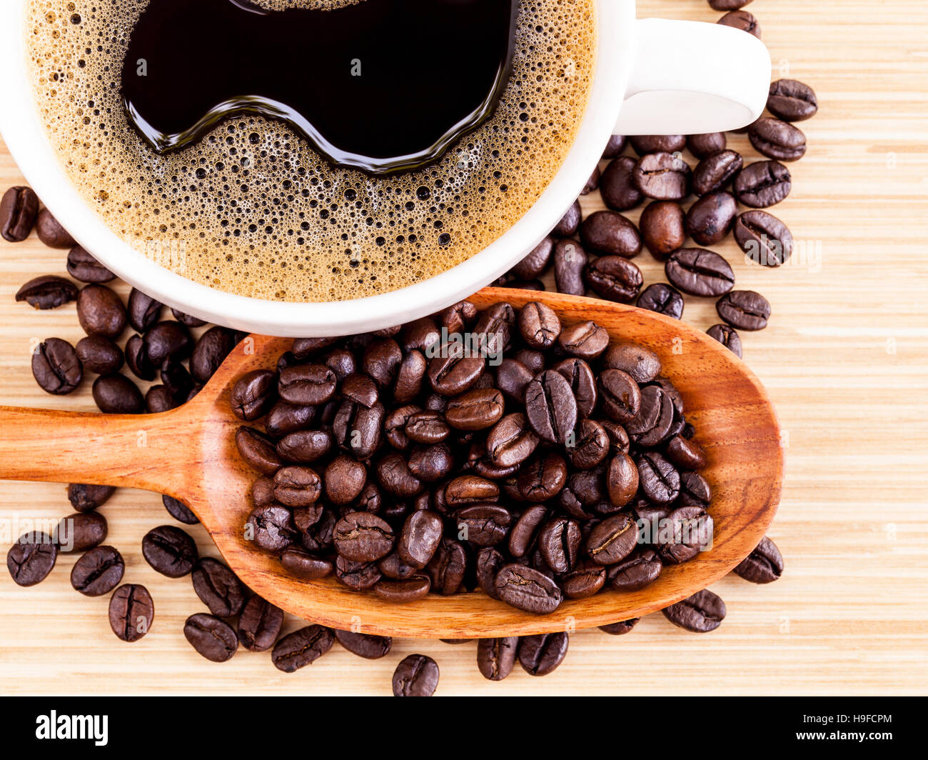 A Coffee cup and coffee beans on wooden panel - With copy space Stock ...