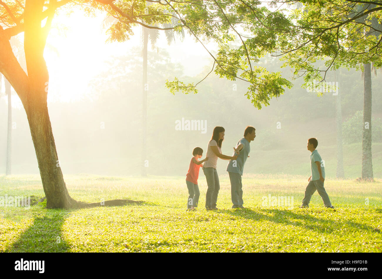 Happy young family having fun outside in summer nature Stock Photo - Alamy