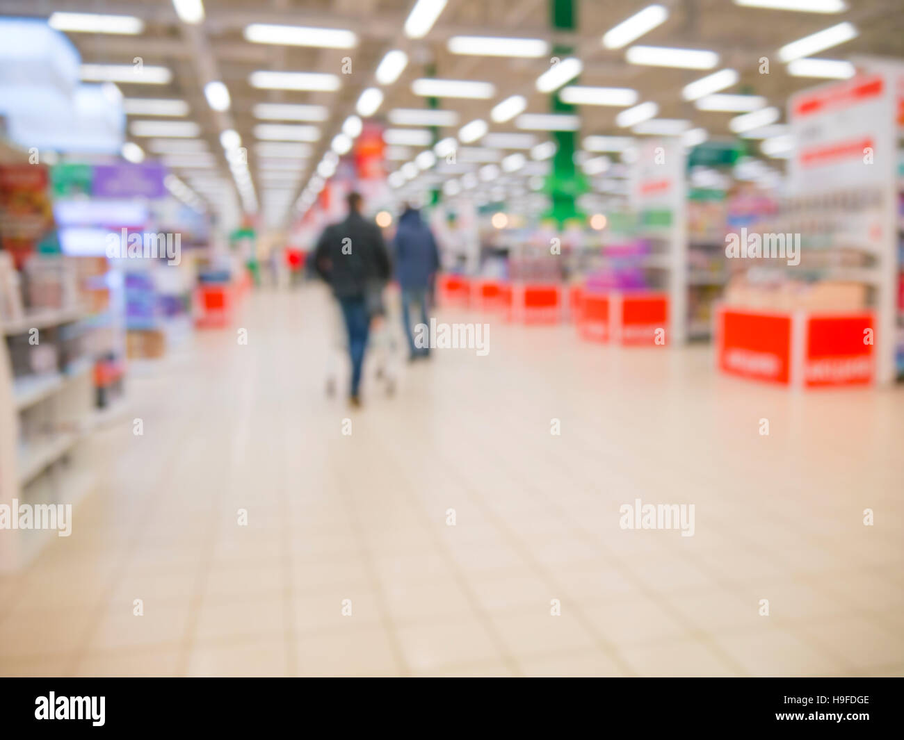 Abstract blurred supermarket aisle with colorful shelves and ...