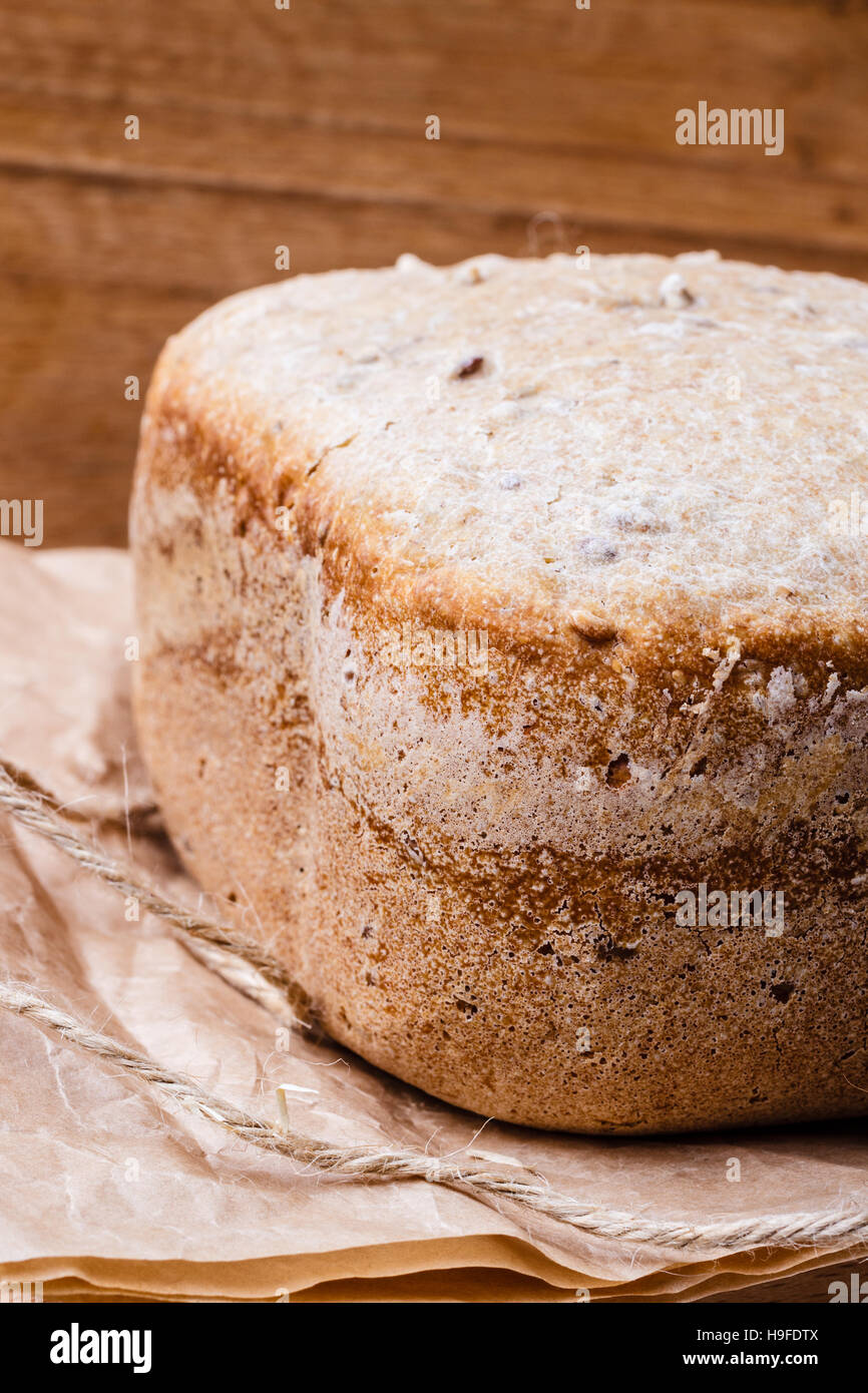 Food. Closeup freshly baked loaf of bread on baking paper Stock Photo ...