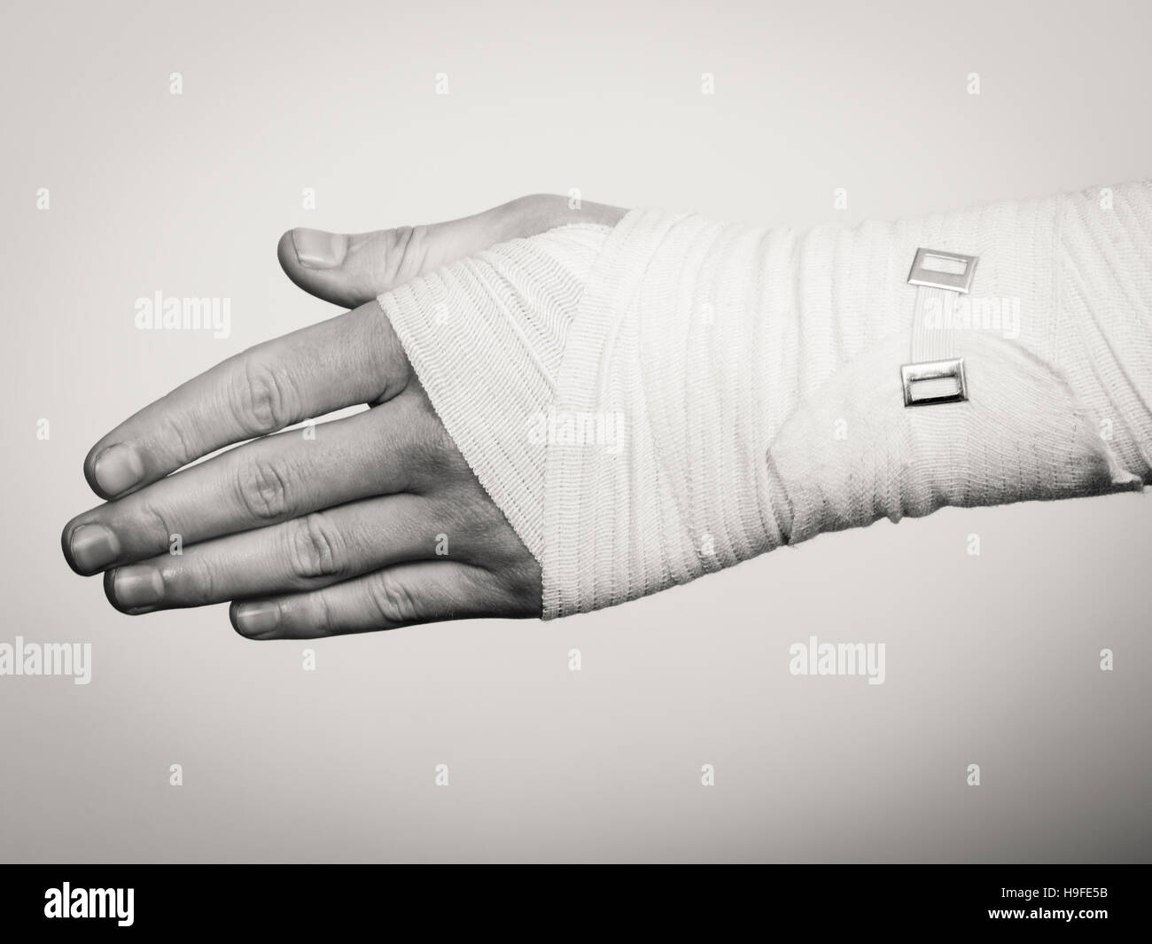 Fractures and dislocations concept. Male hand in white bandage. Helpful ...