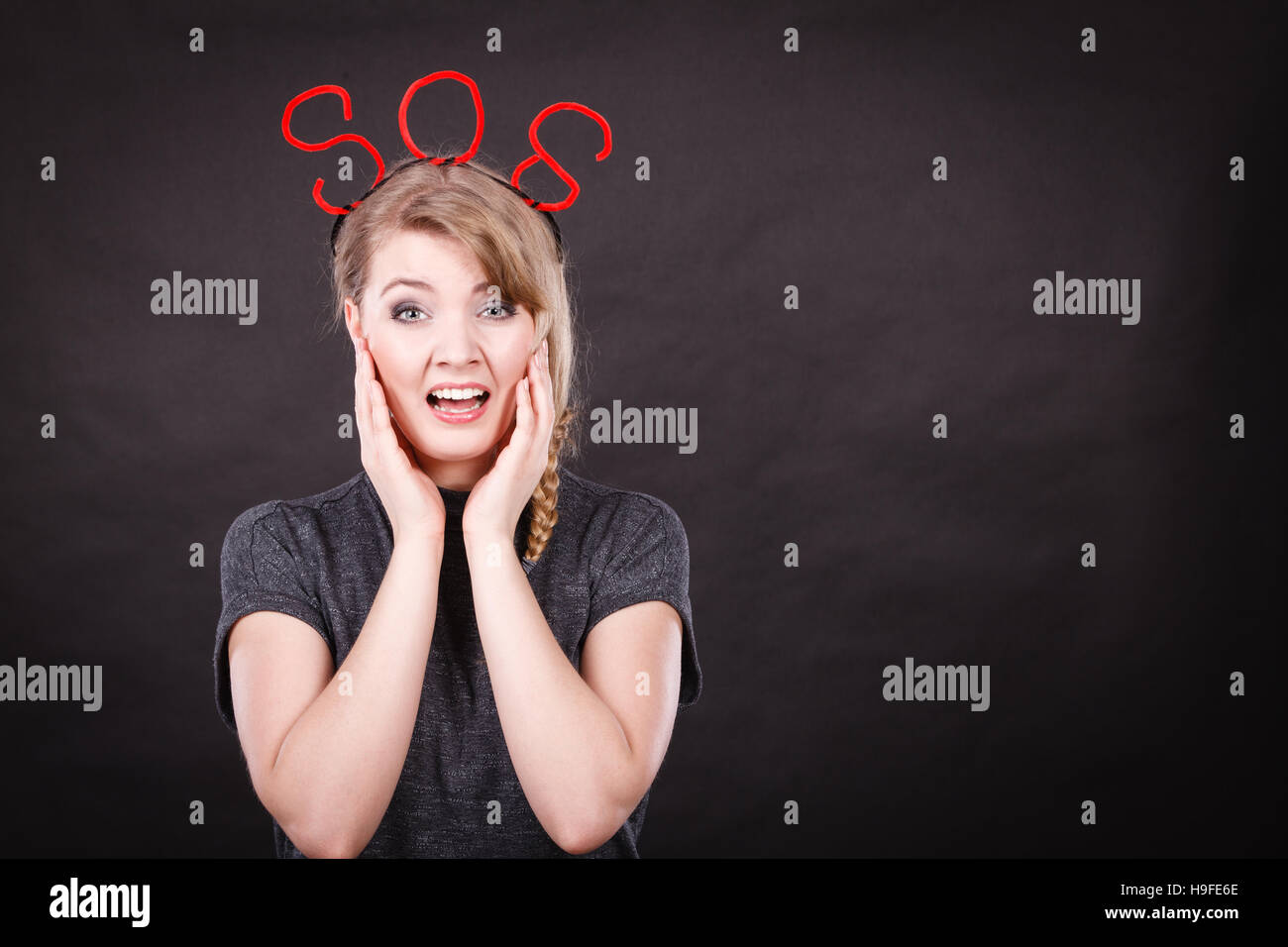 Fear and fright. Young blonde terrified woman needs help. Frightened ...