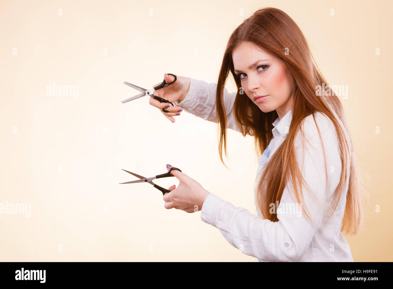 Cutting as a way of healthy strong hair. Girl barber with scissors ...