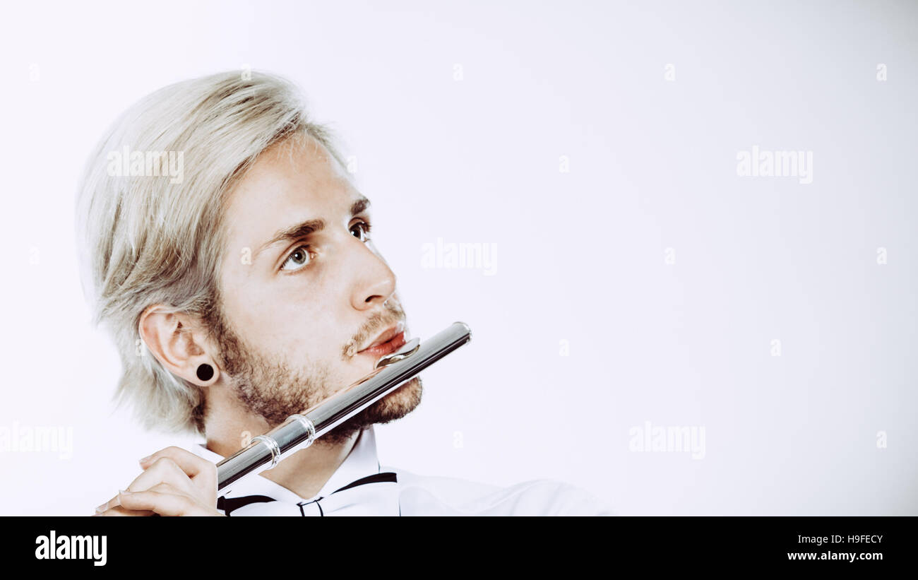 Flute music playing professional male flutist musician performer. Young ...