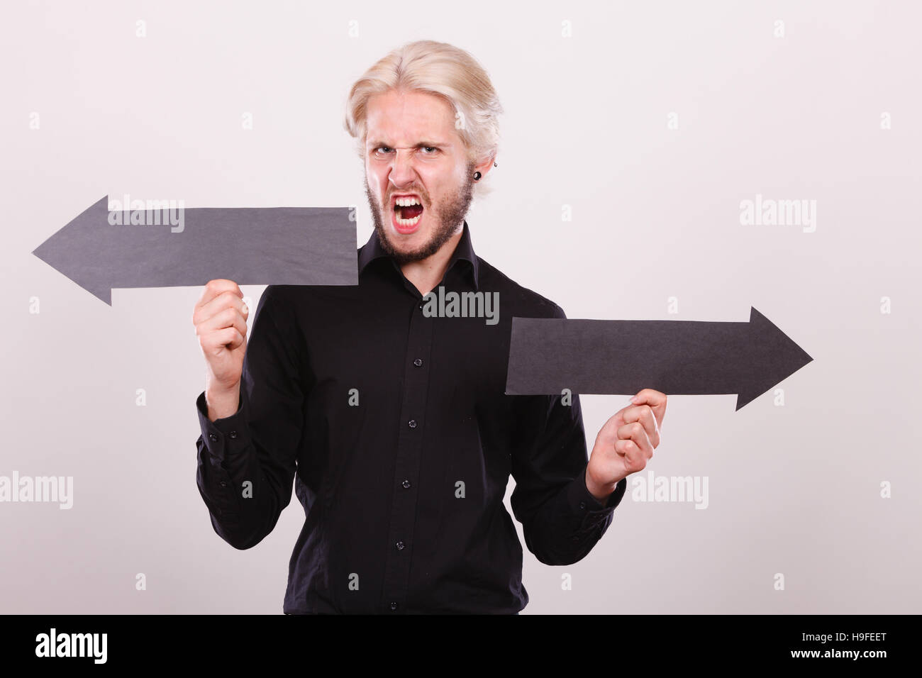 Planning, directions, choices concept. Furious angry man holding black ...