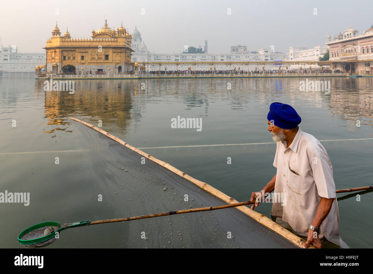 A Sikh cleans the Sarovar (water tank) – around the Golden Temple (Sri ...