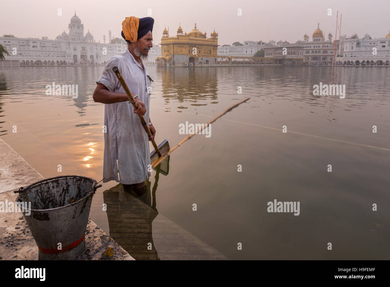 A Sikh cleans the Sarovar (water tank) – around the Golden Temple (Sri ...