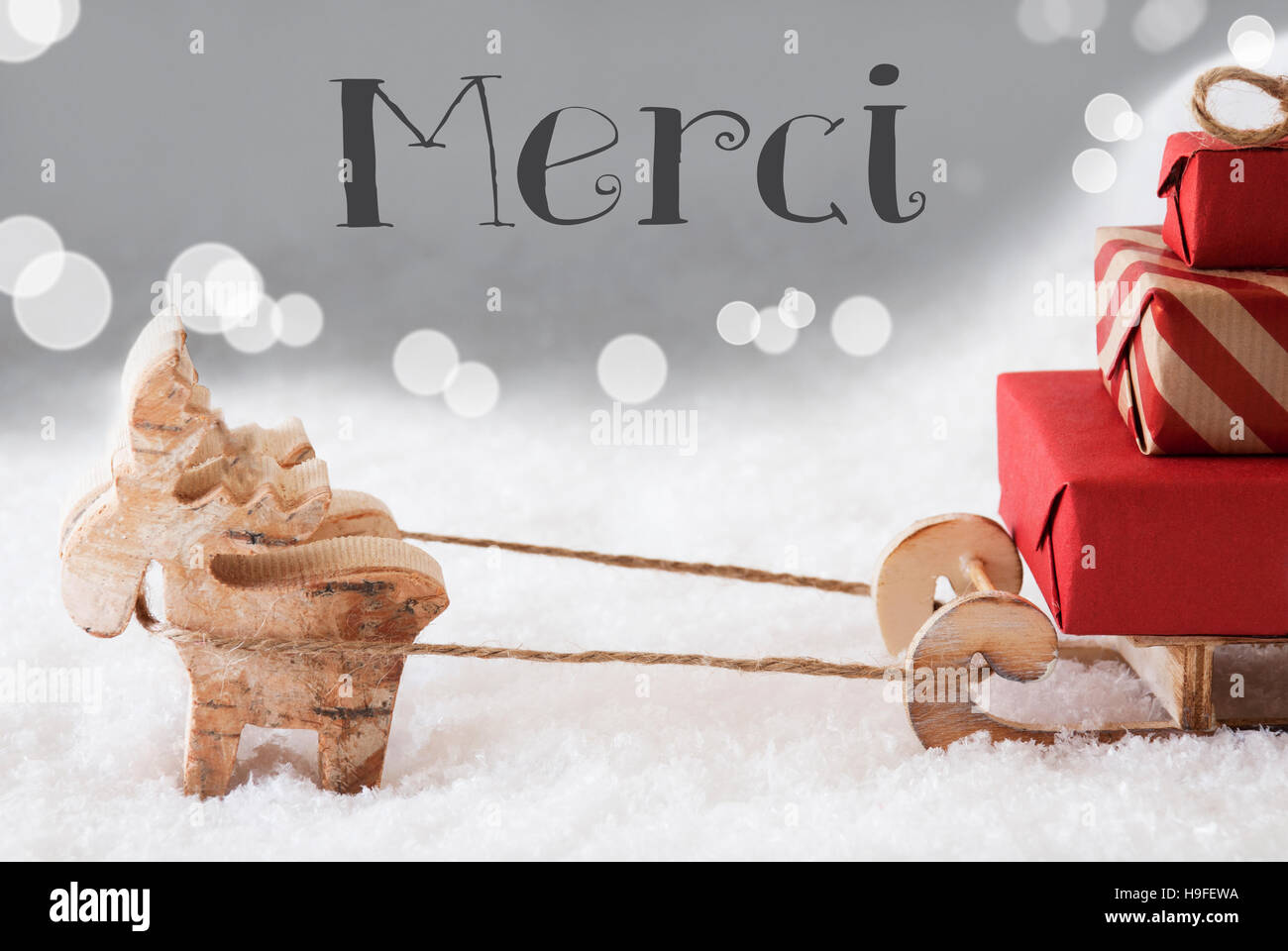 Reindeer With Sled, Silver Background, Merci Means Thank You Stock ...