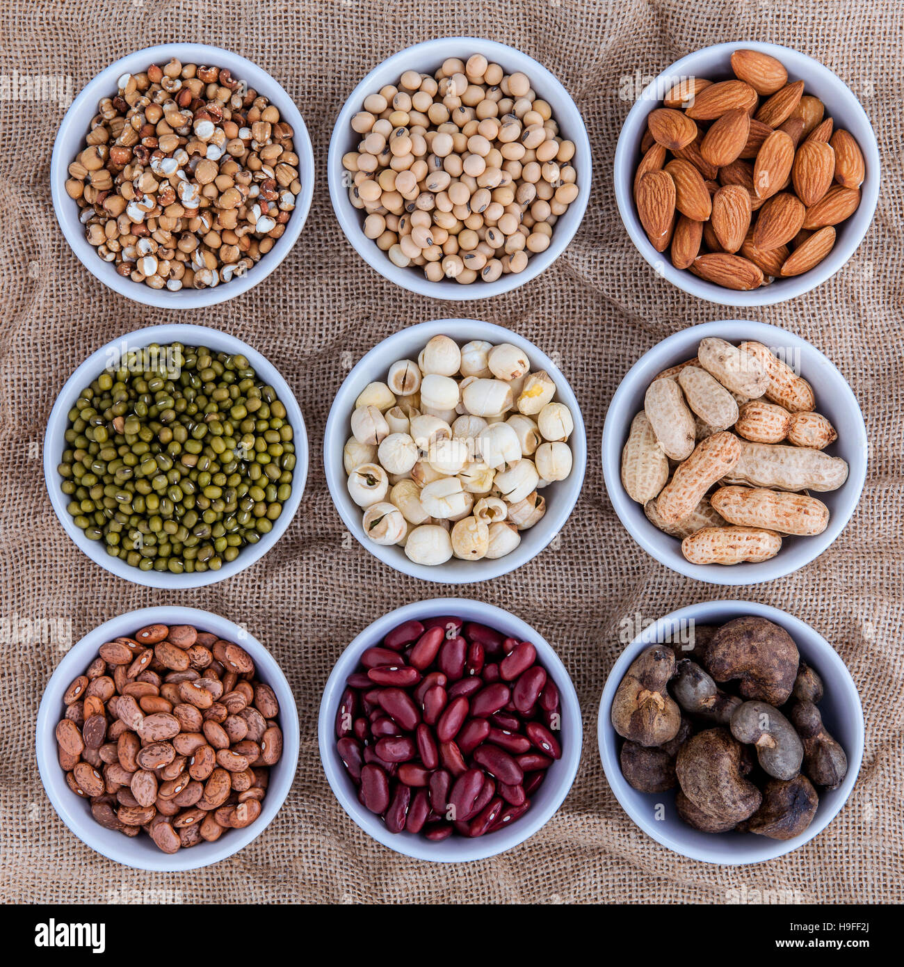 Mixed beans , lentils and nuts in the white bowl on brown cloth Stock ...
