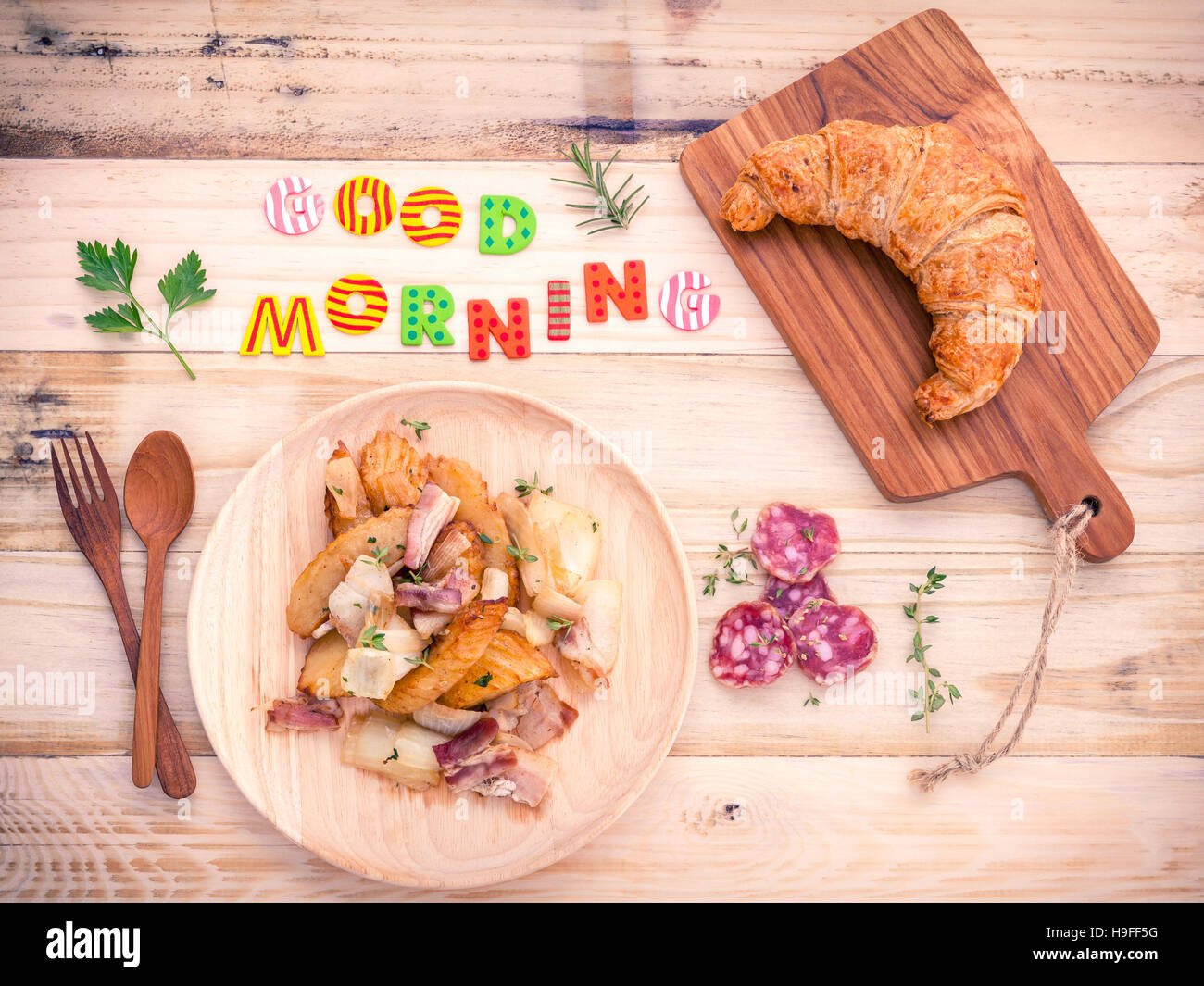 Breakfast setup on wooden table with colourful Good Morning wor Stock ...