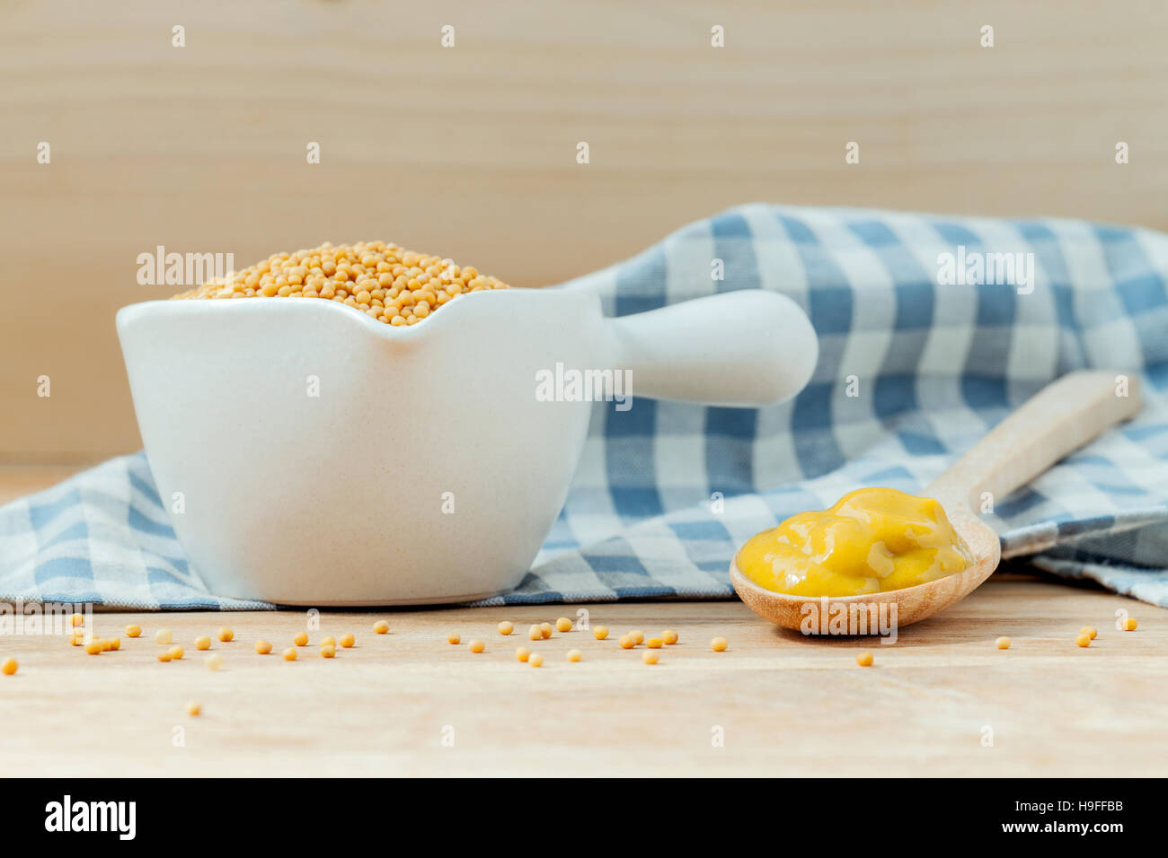 Composition of mustard and mustard seeds on wooden background Stock ...