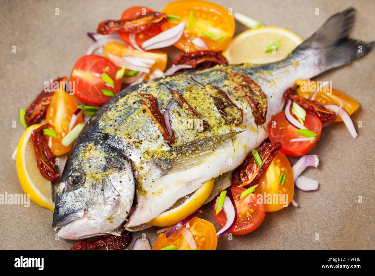 Raw whole sea bream fish and vegetables ingredients, ready to cook ...