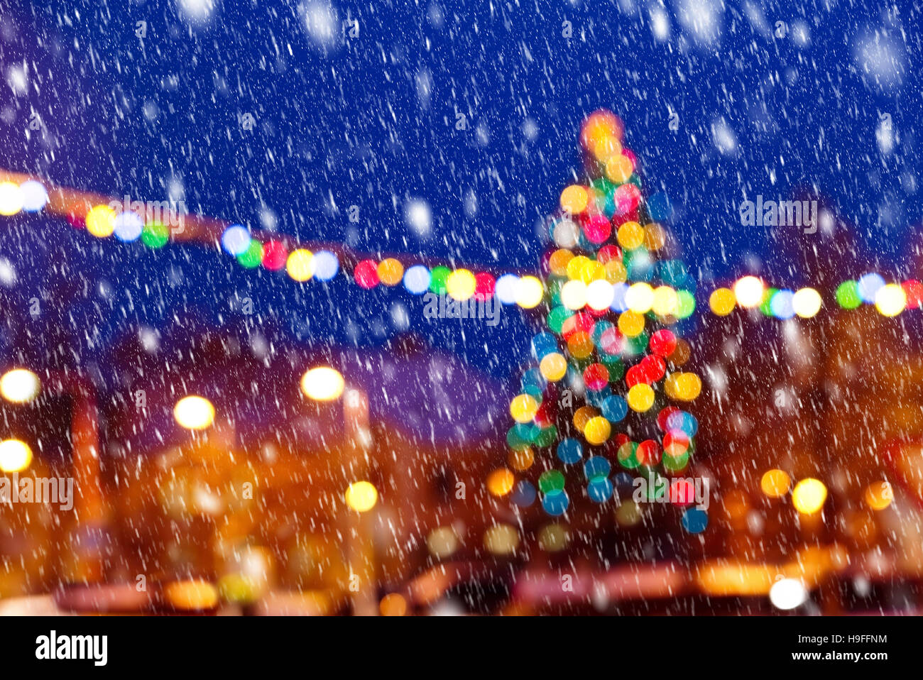 Christmas background with unfocused Christmas tree and snow by night ...