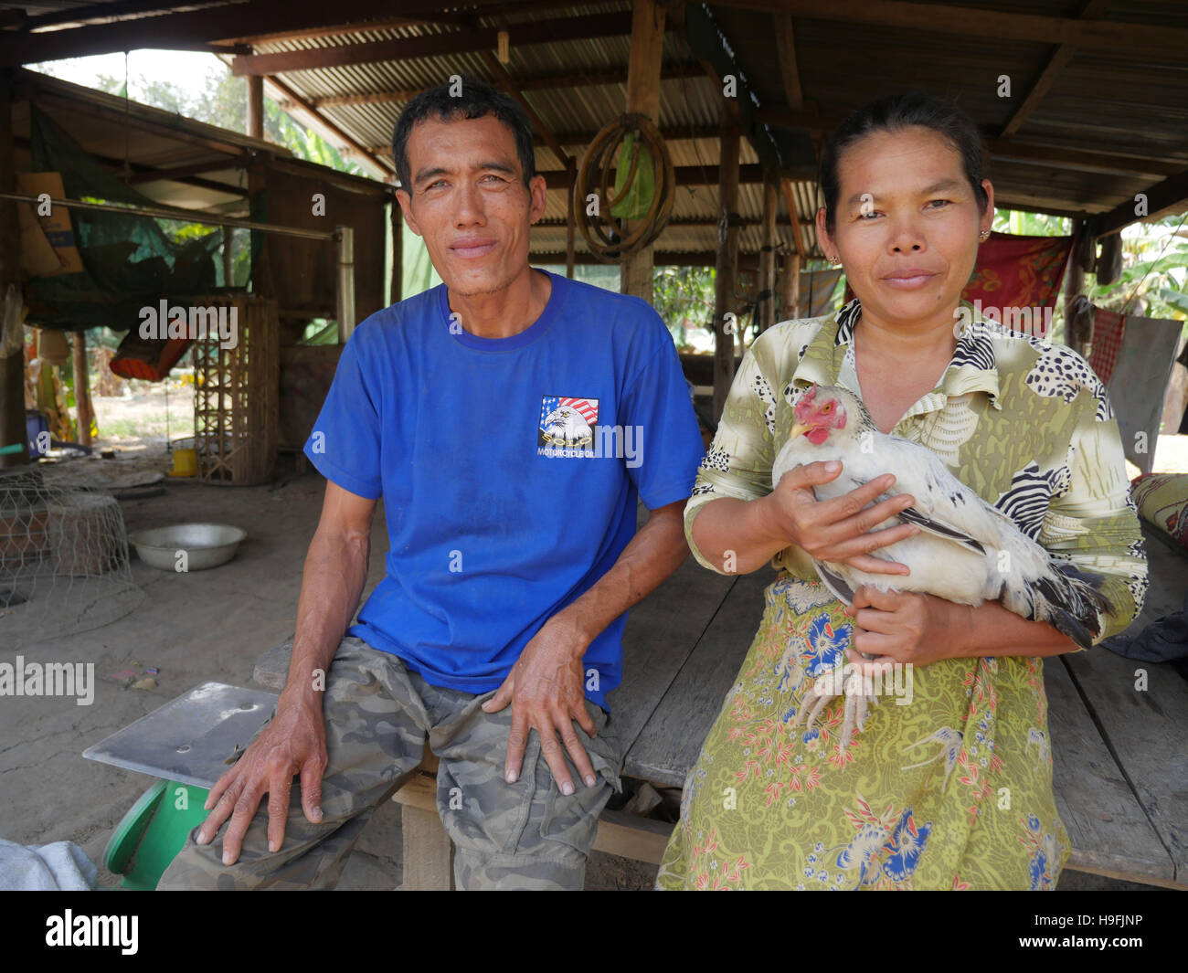 Cambodia, Stung Treng. Couple with hen. Sean Sprague photo Stock Photo ...