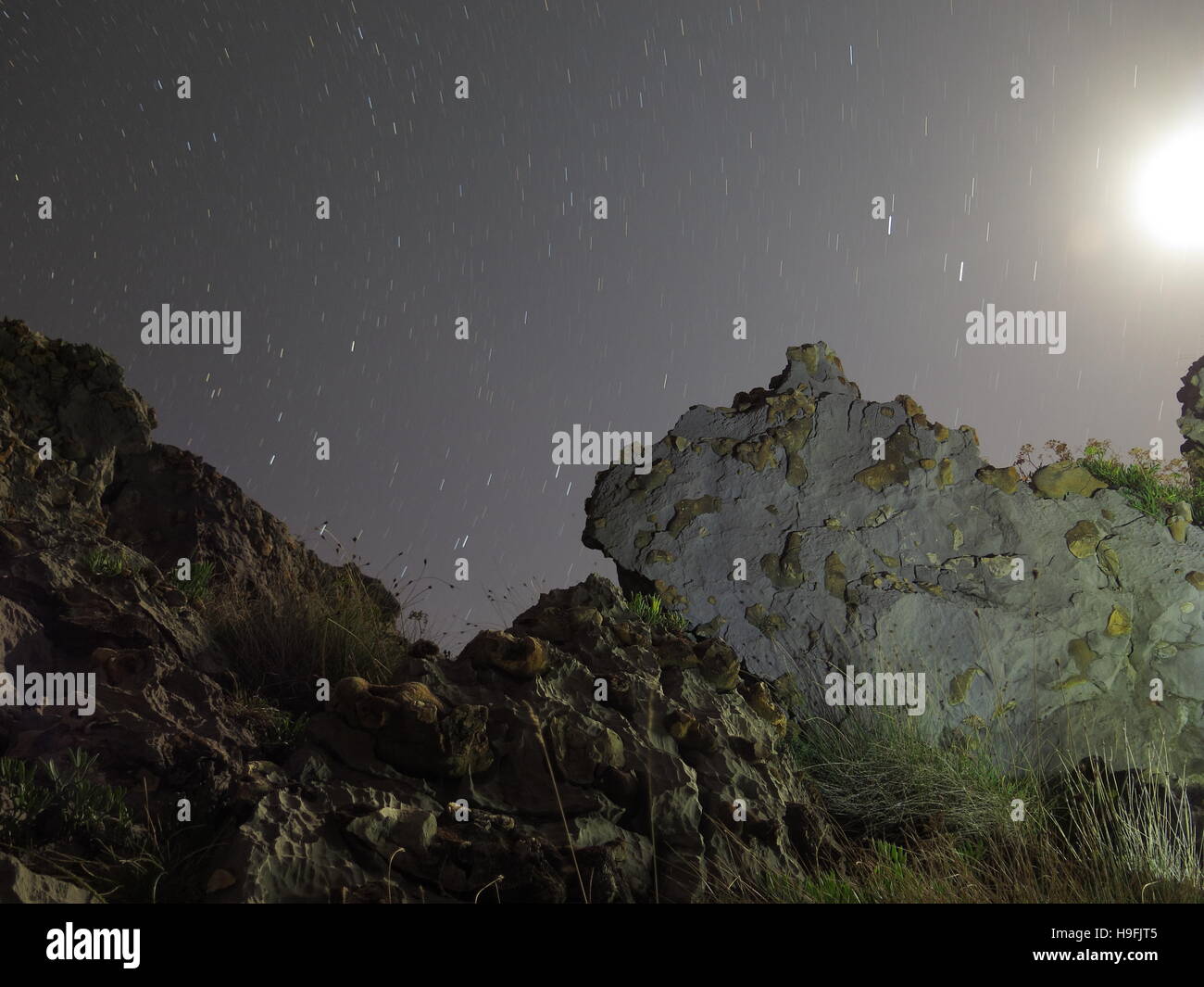 rocks at night with the moon Stock Photo - Alamy