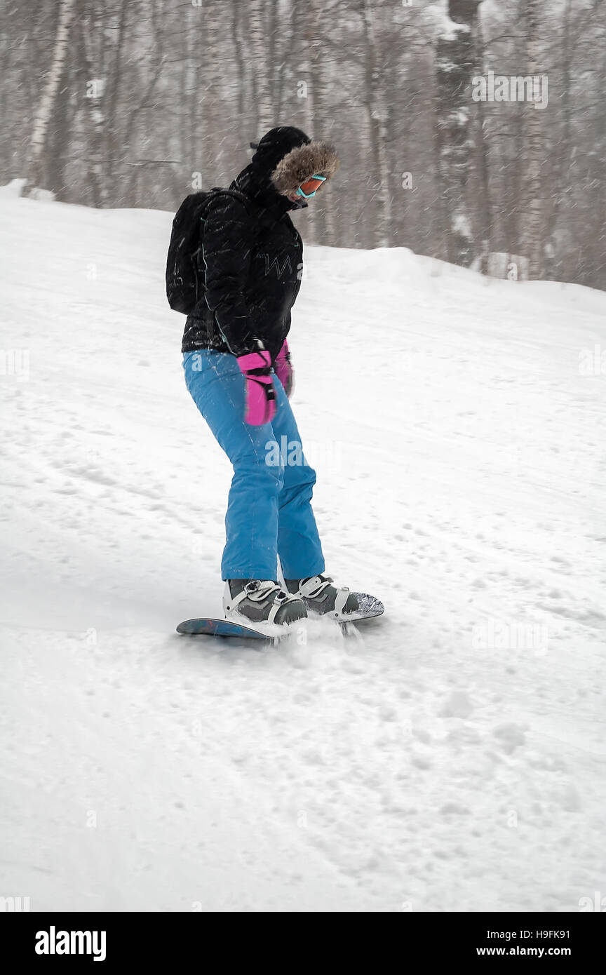 Woman doing exercise on snowboard Stock Photo - Alamy