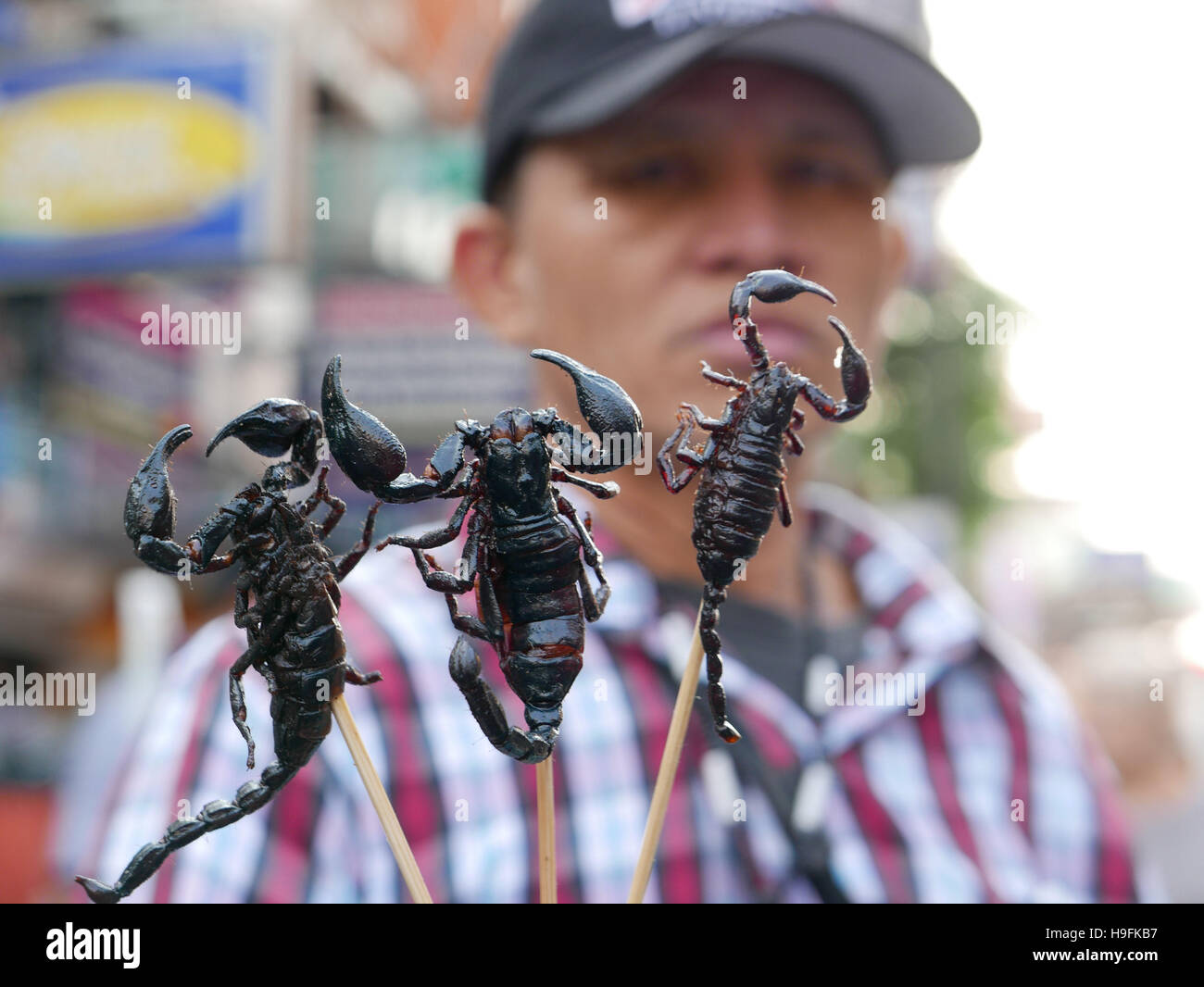 THAILAND Bangkok. Khao San Road. Man selling scorpions to eat. Sean ...