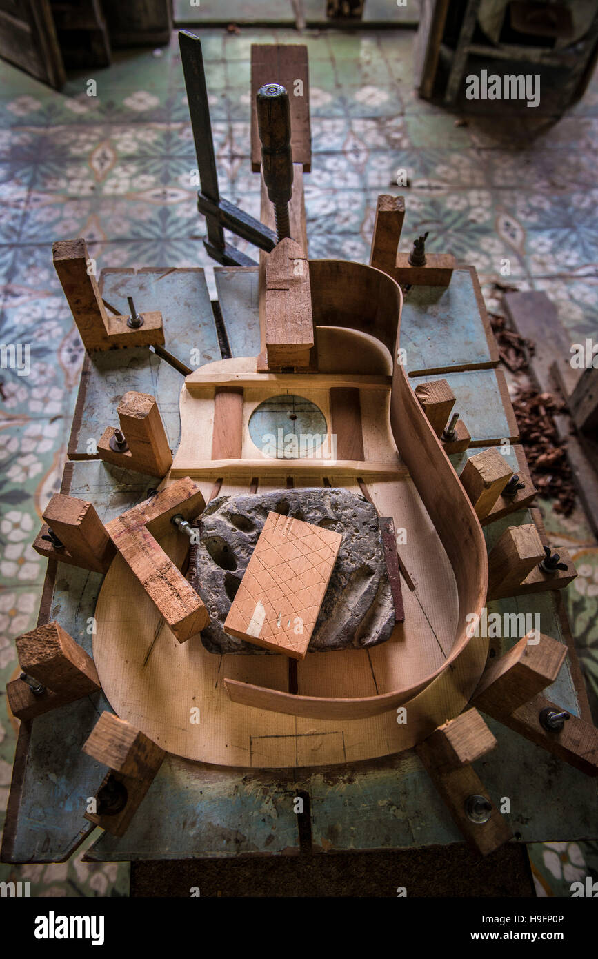 A Cuban guitar, or "tres" being clamped together in a hand-made guitar ...