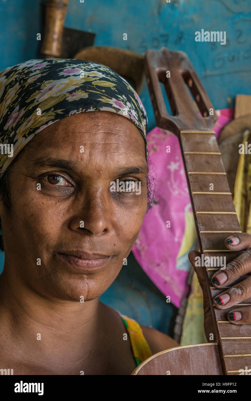 A Cuban woman proudly holding the guitar or "tres" she is working on ...