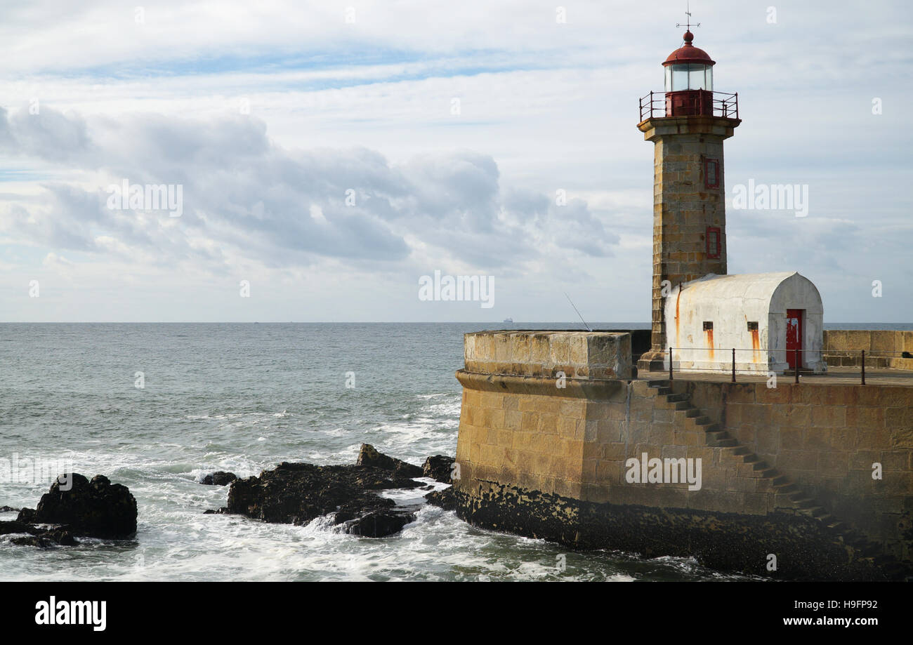 Lighthouse in Porto with wave splash at Autumn light, Porto, Portugal ...