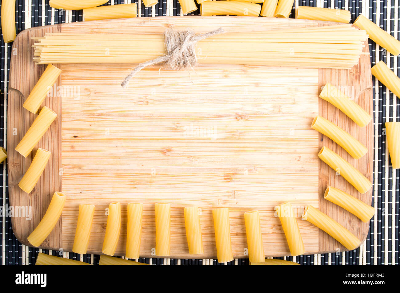 Food background of wooden boards decorated with pasta and spaghetti ...