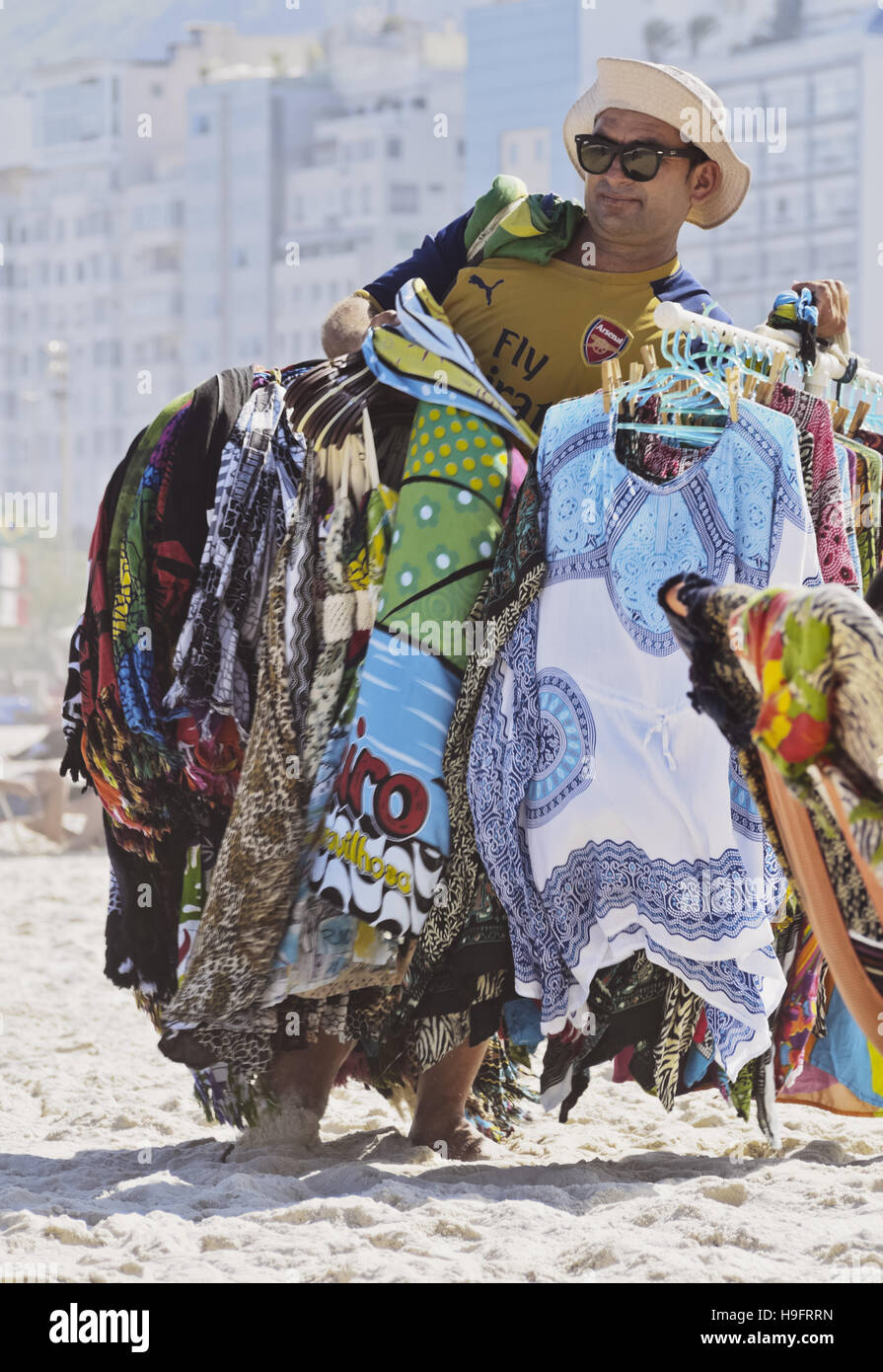 Brazil, City of Rio de Janeiro, Man selling clothes on Copacabana Beach ...