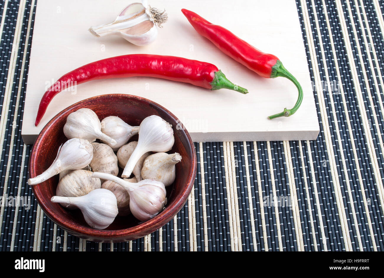 Spice background for cooking - cayenne chillies and garlic in a brown ...