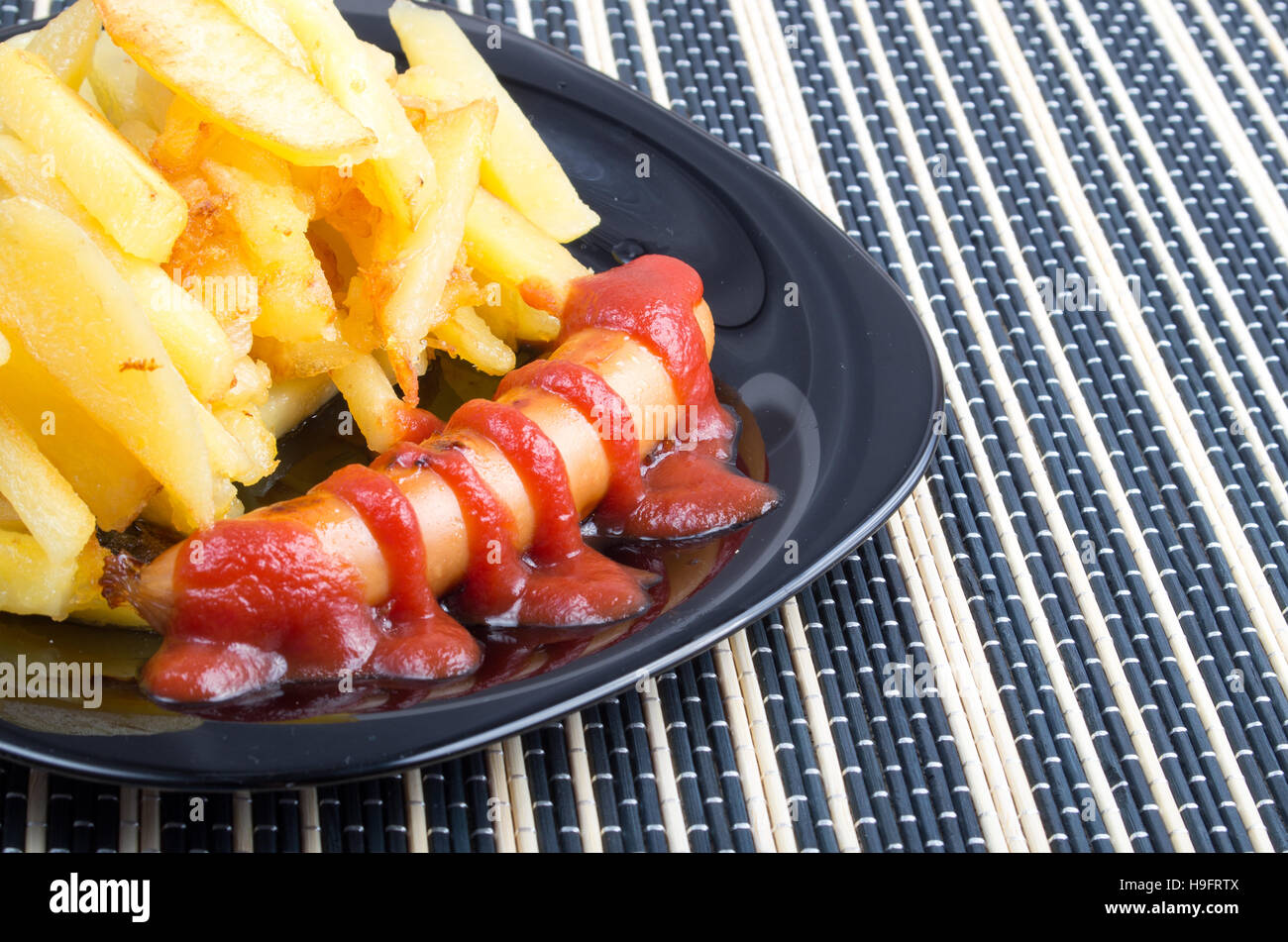 Typical Russian dish - fried potatoes and fried sausage with tomato ...