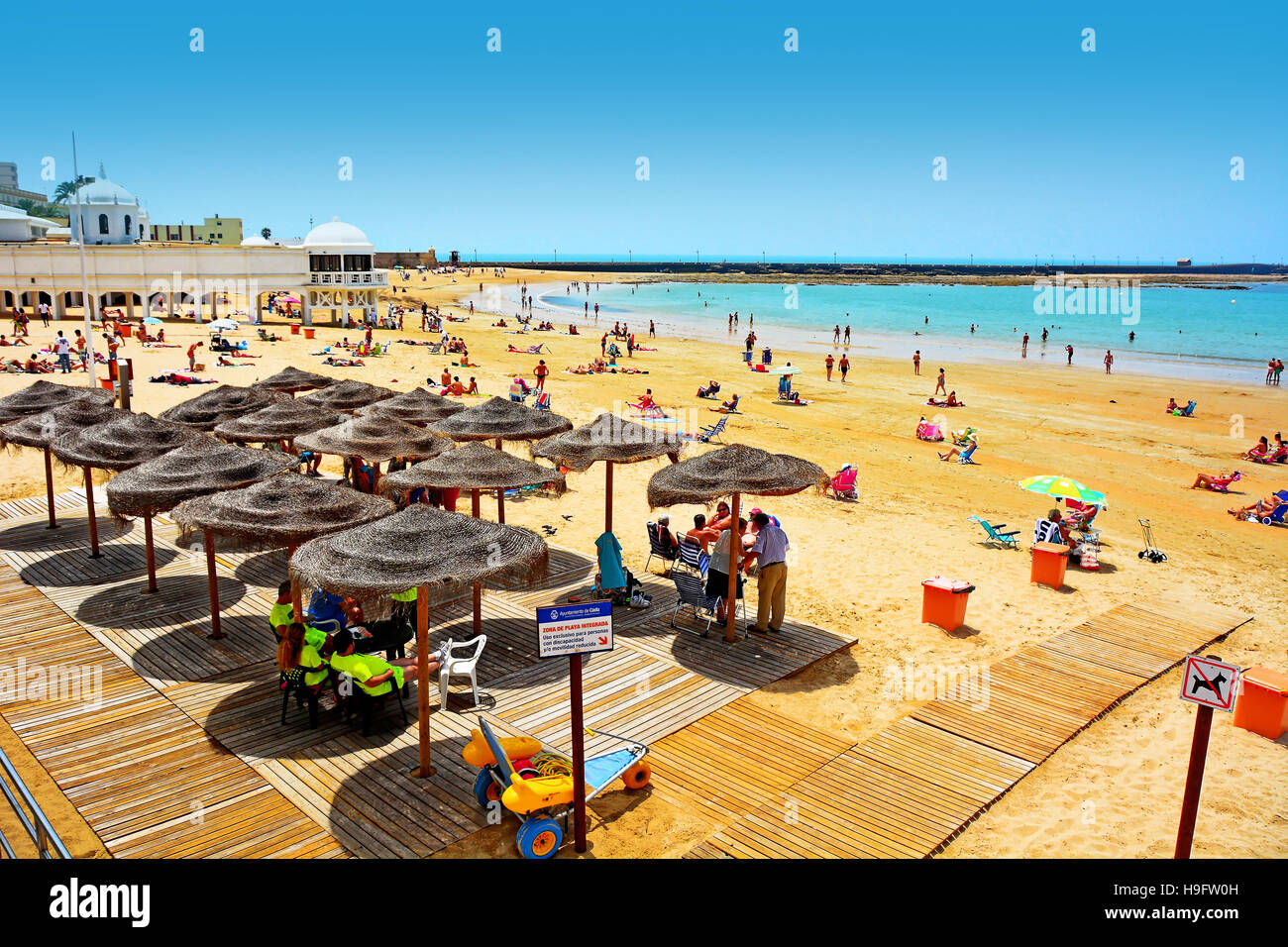 Cadiz beach and sun soaking tourists blue sky Stock Photo - Alamy