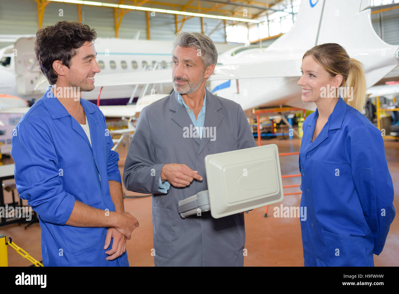 Aviation apprentices with tutor Stock Photo - Alamy