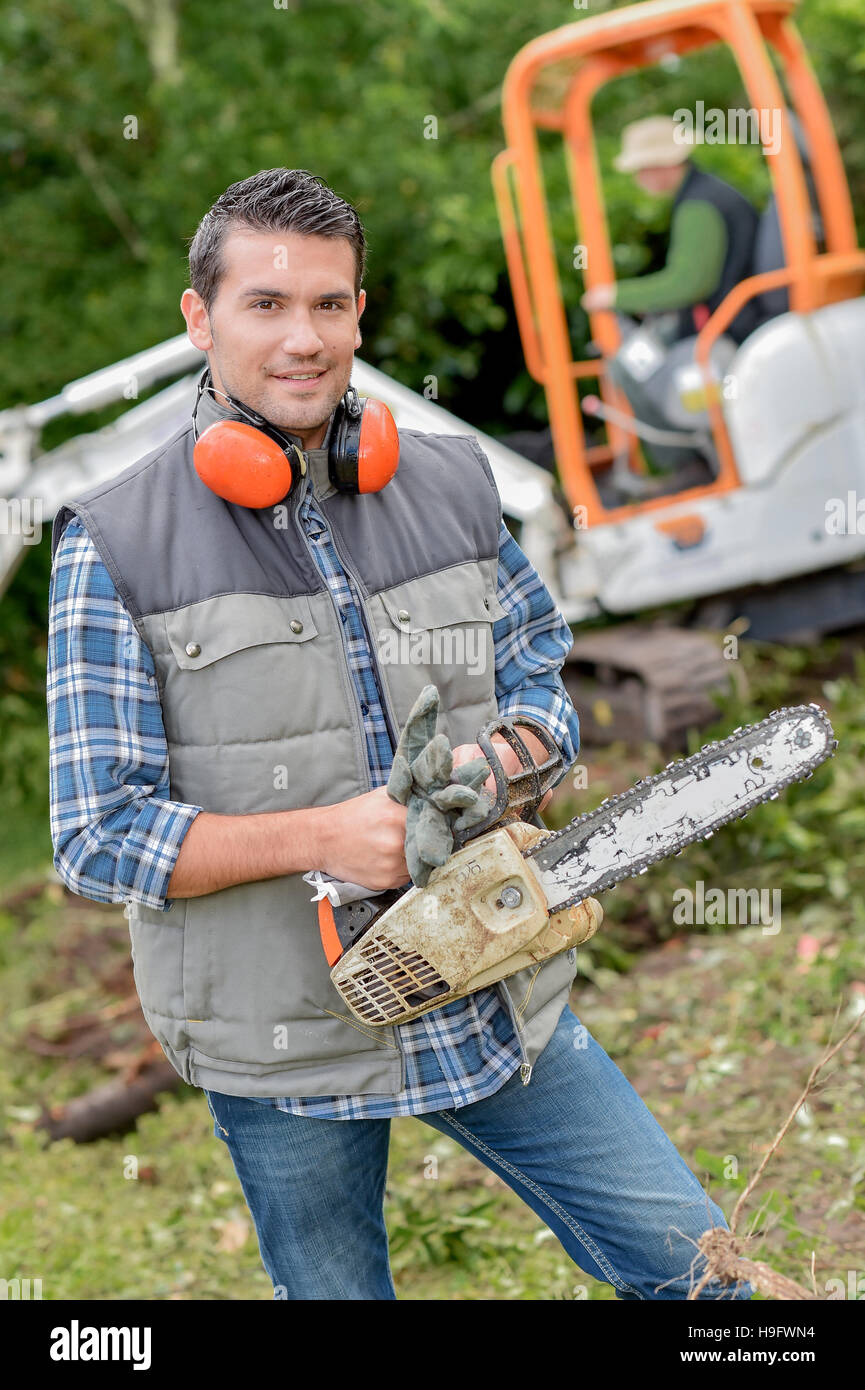 Landscape gardener with a chainsaw Stock Photo - Alamy