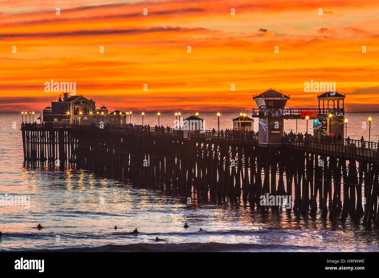 sunset at oceanside pier with surfers and palm tree Stock Photo - Alamy
