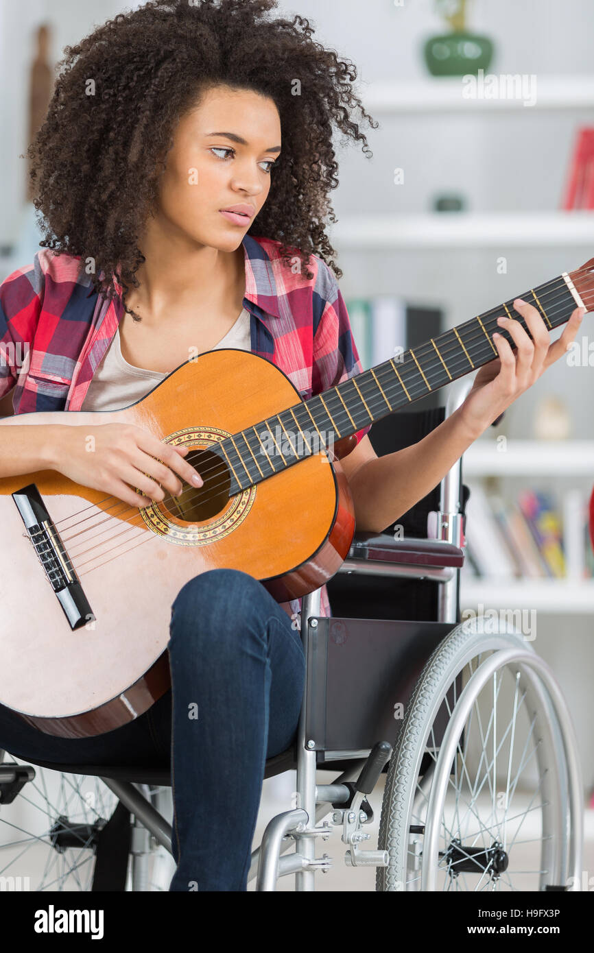 young handicapped guitarist woman sitting on wheelchair Stock Photo - Alamy