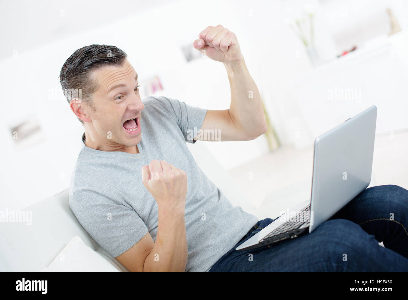 very happy man with laptop Stock Photo - Alamy