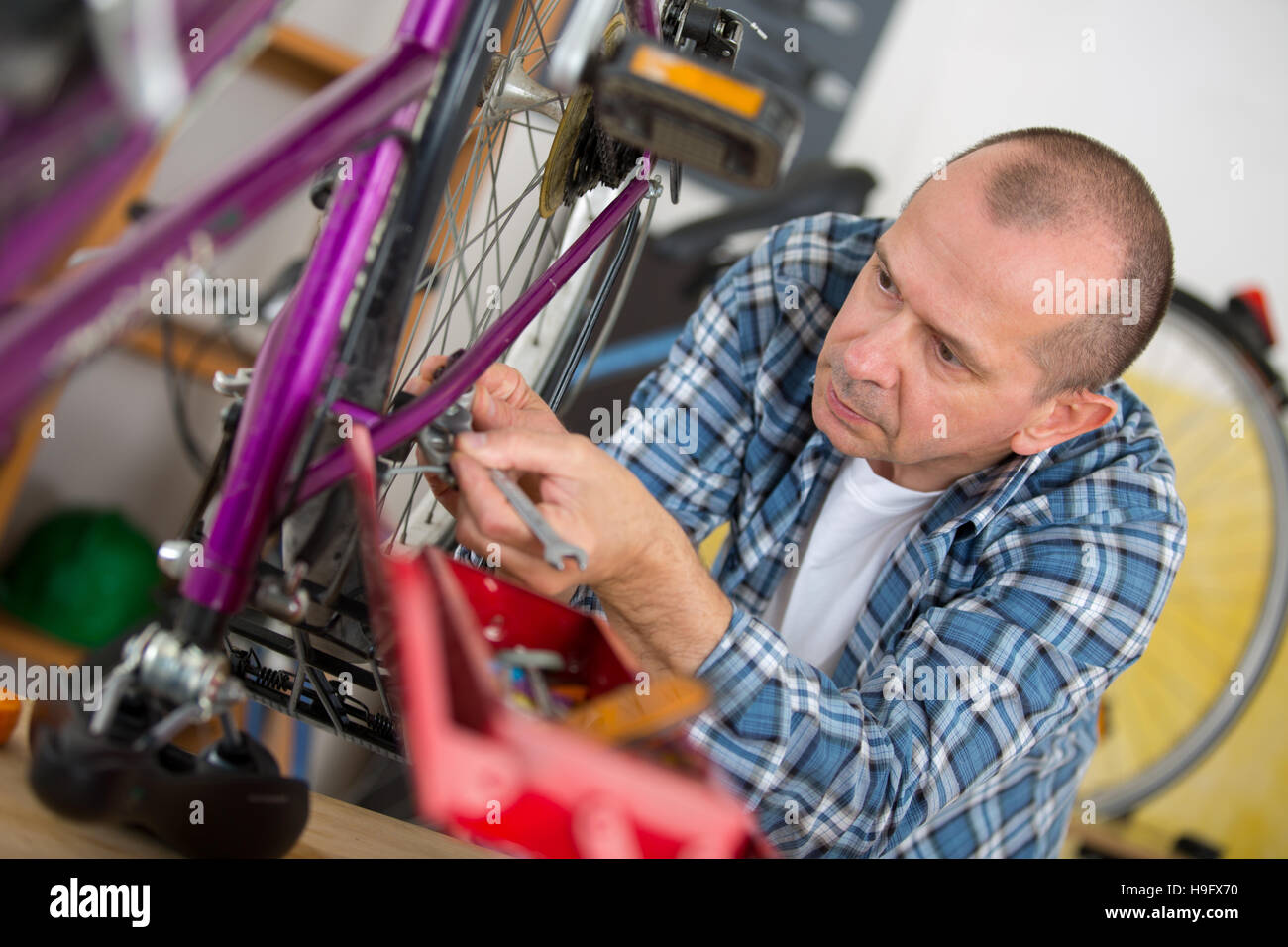 Mechanic working on bicycle hi-res stock photography and images - Alamy