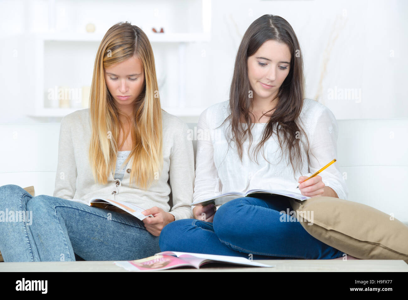 two girls doing homeworks at home Stock Photo - Alamy